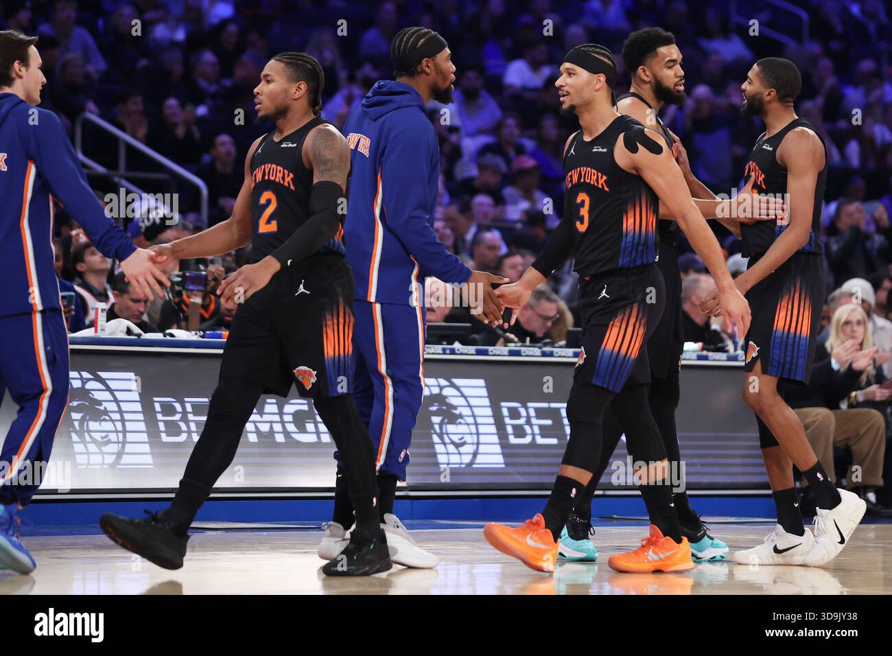 New York Knicks players high-five during a timeout in the first half of an NBA basketball game ...