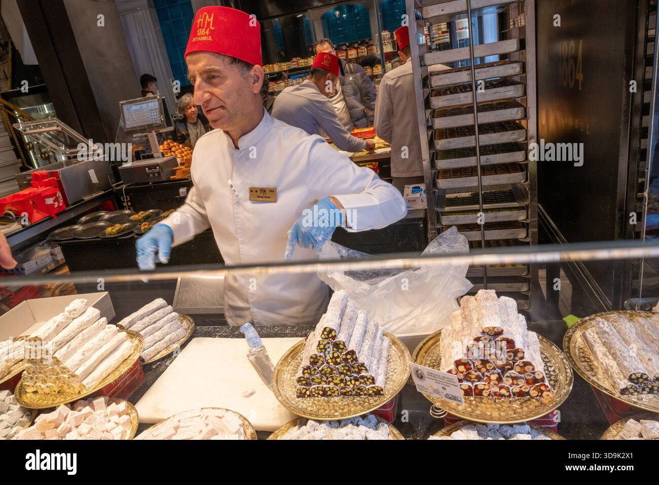Turkish fez wearing staff inside Hafiz Mustafa baklava sweet shop along ...