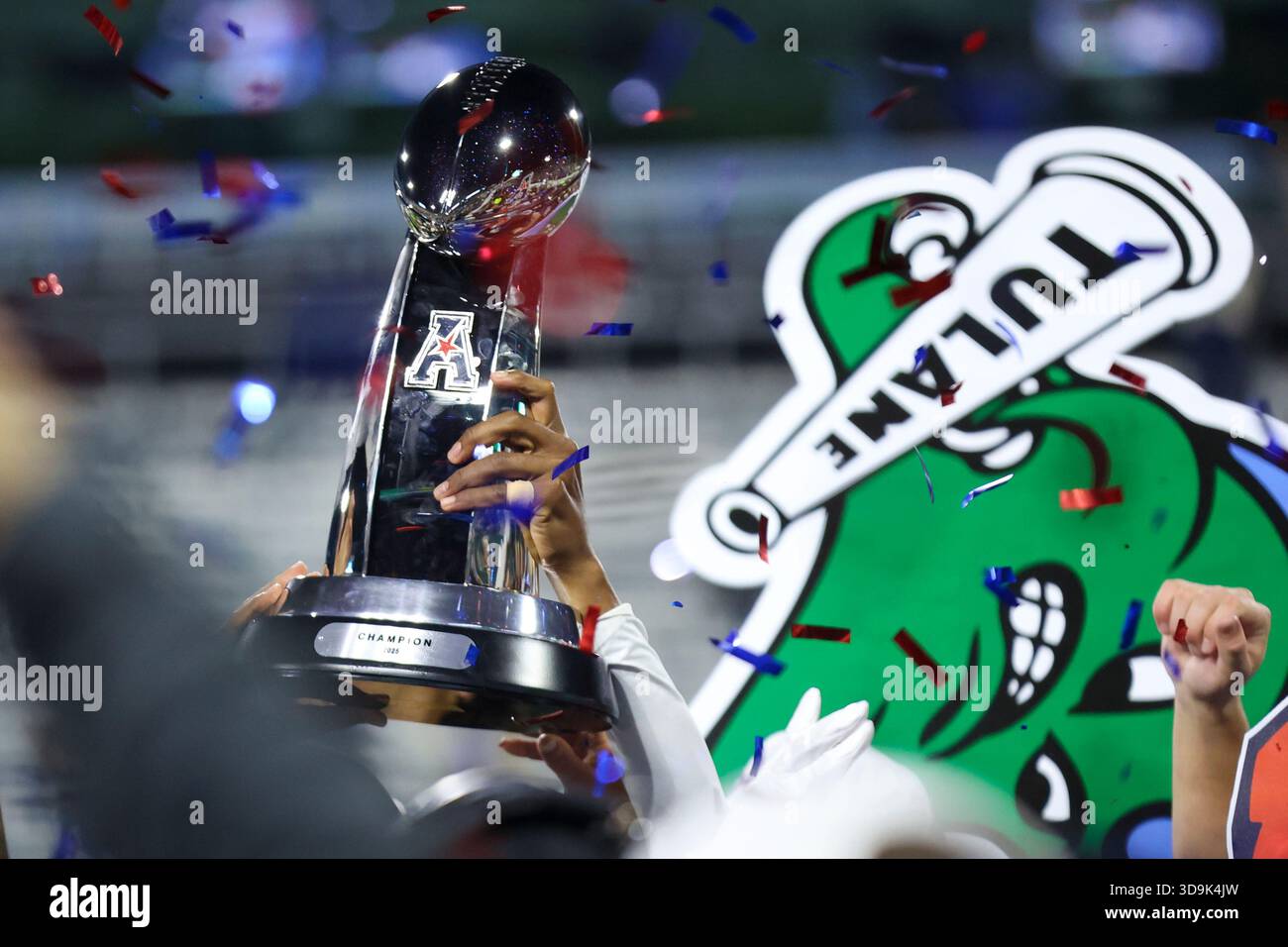 A Tulane Green Wave player holds up the American Conference football ...
