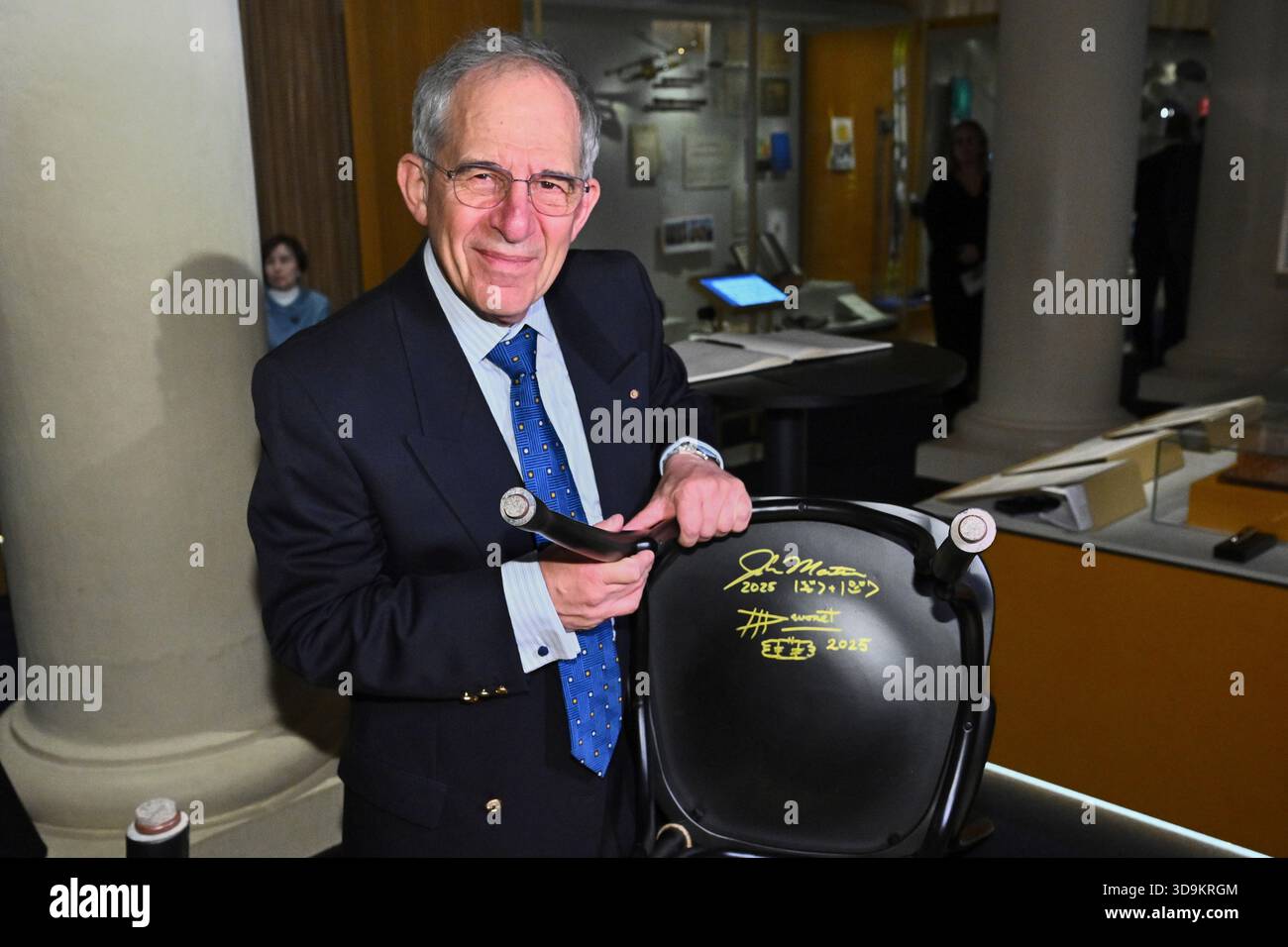 Michel H. Devoret, laureate in physics, shows his signature on a Nobel ...