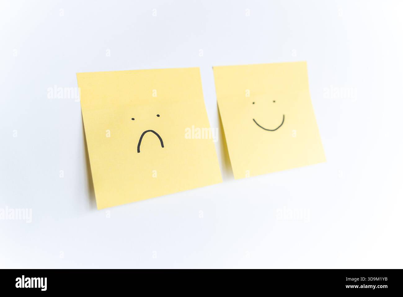 Yellow sticky notes with smile and sad faces Stock Photo - Alamy