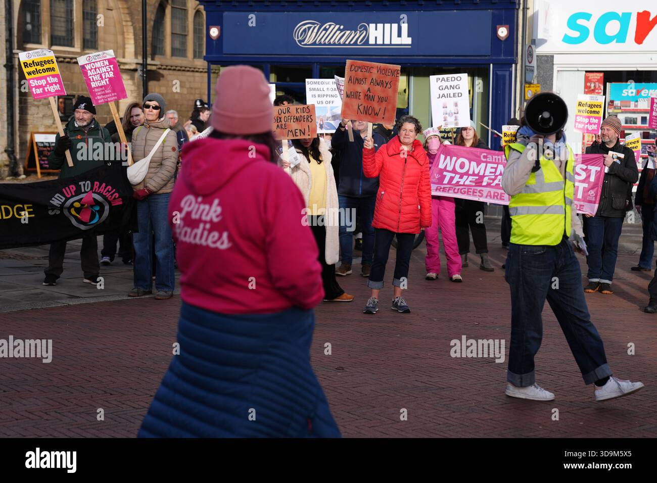 People take part in a Pink Ladies rally in Huntingdon (foreground) with ...