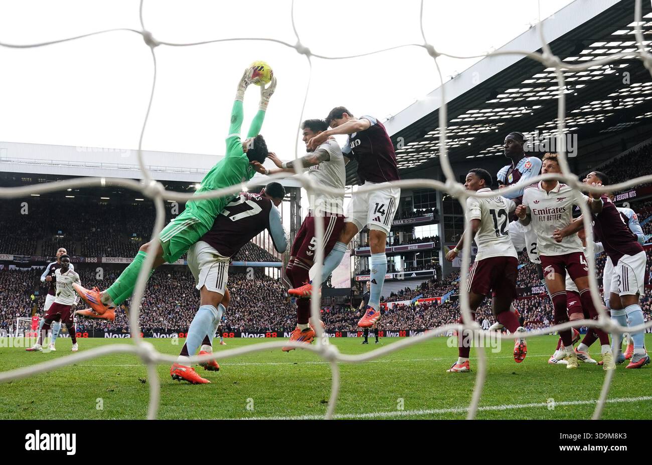 Arsenal goalkeeper David Raya collects the ball under pressure from ...