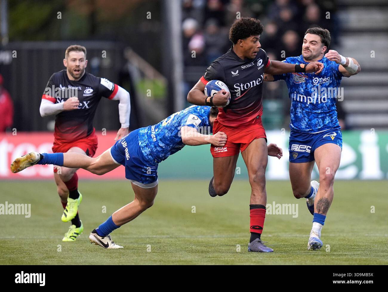 Saracens' Noah Caluori (centre) is tackled by ASM Clermont Auvergne's Axel Guillauda (second ...