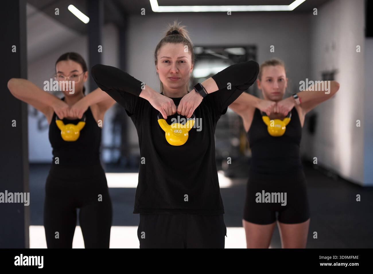 Women group perform kettlebell exercises hi-res stock photography and ...
