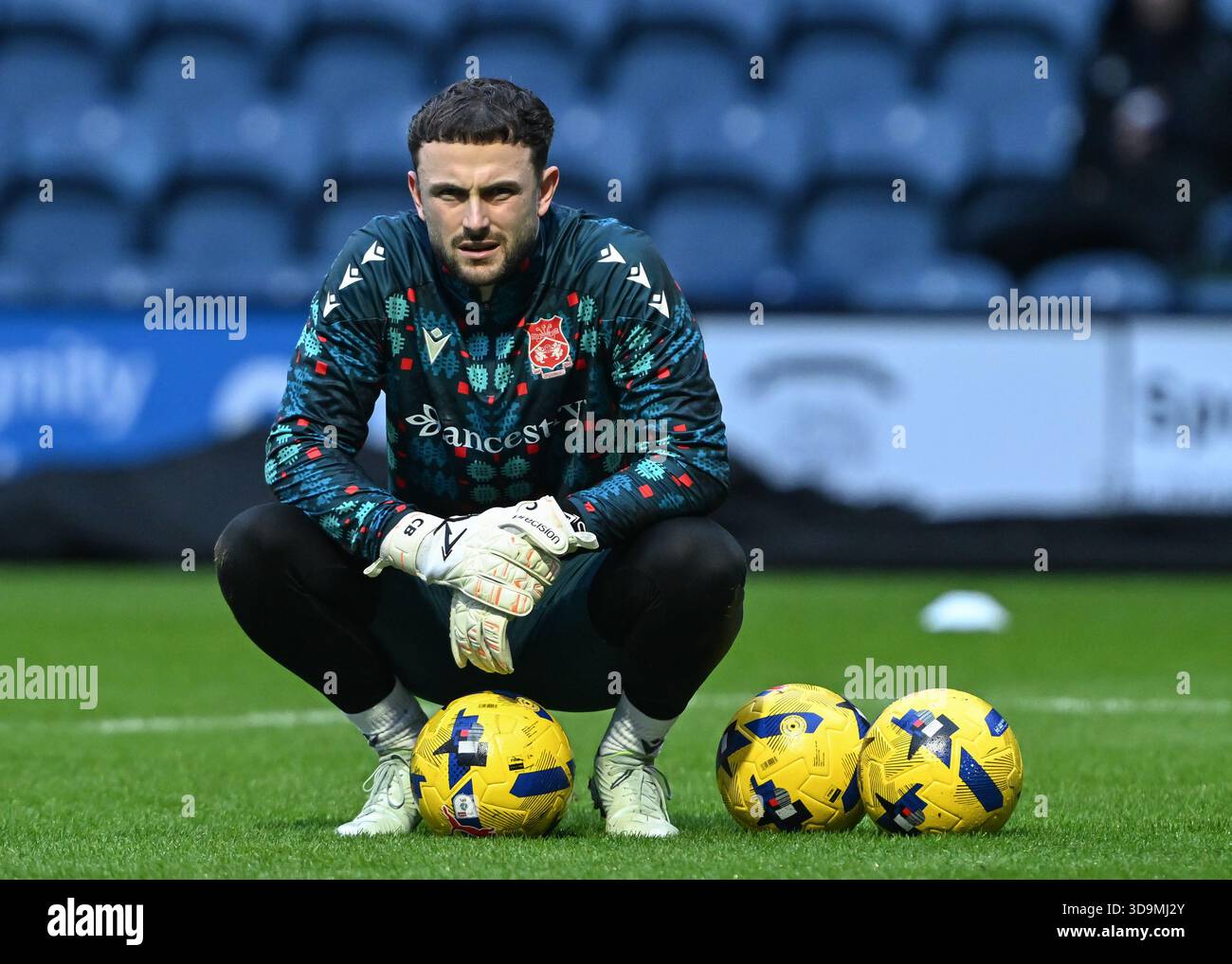 Wrexham goalkeeper Callum Burton warms up ahead of the Sky Bet Championship match at Deepdale ...