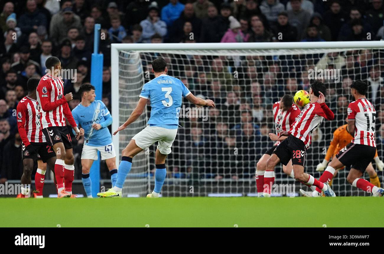 Manchester City's Ruben Dias scores their side's first goal of the game ...