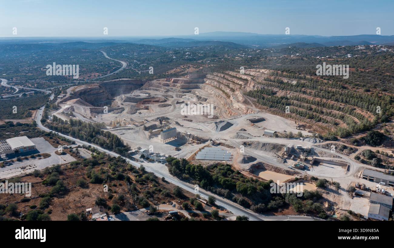 Open pit mining site showcasing heavy machinery and layered terrain ...