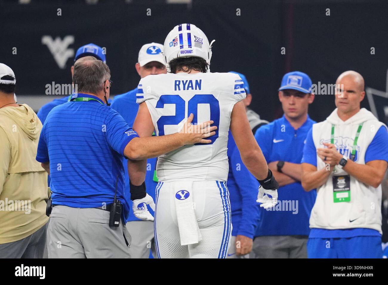 BYU tight end Carsen Ryan (20) is helped off the field after suffering ...