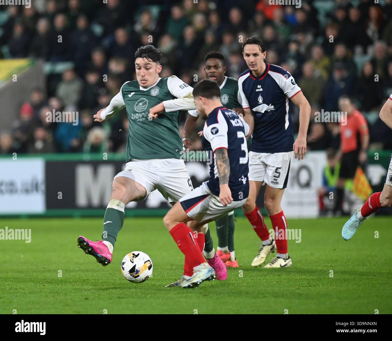 Kieron bowie of hibs with leon mccann of falkirk hi-res stock ...