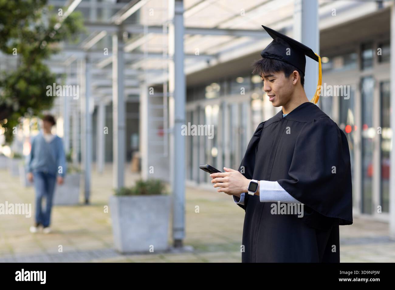 Asian male graduate checking hi-res stock photography and images - Alamy