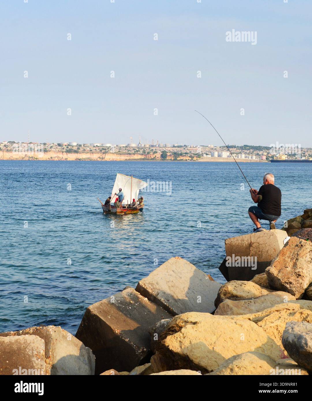 LUANDA, ANGOLA - FEB 03, 2025: People on a wooden sail boat in the sea ...