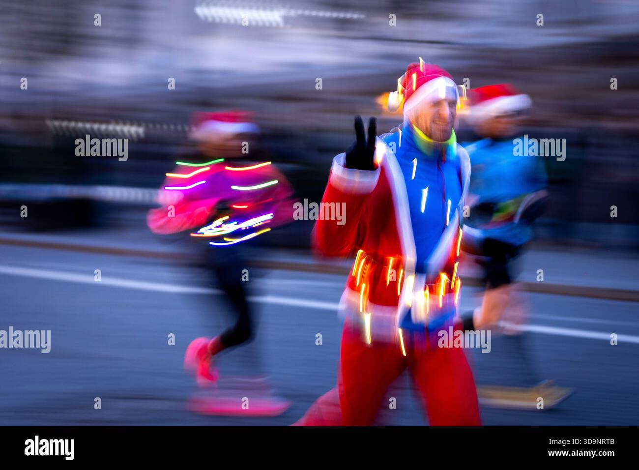 Runners dressed as Santa Claus, run during the traditional Christmas ...
