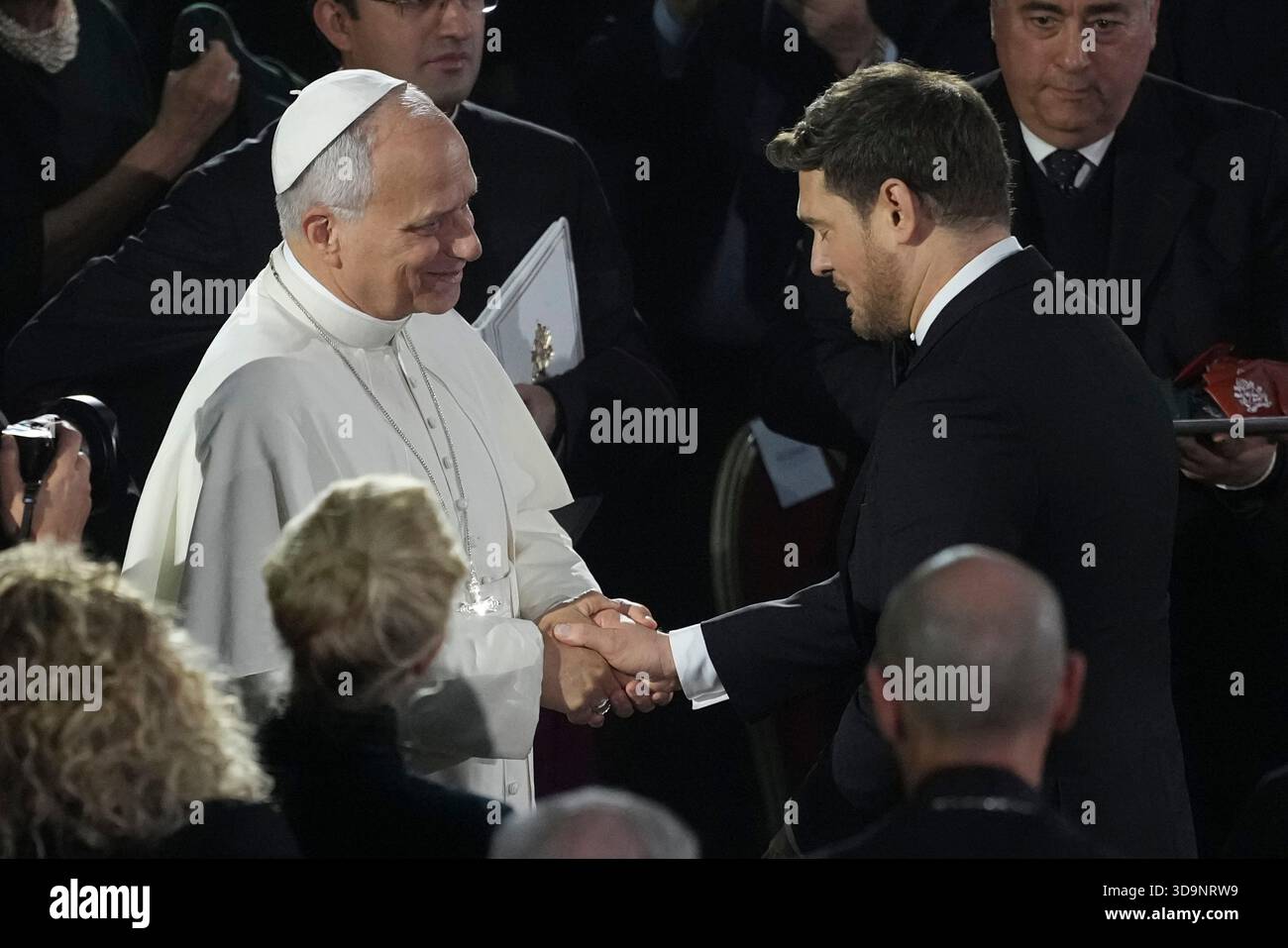 Pope Leo XIV congratulates Canadian pop singer Michael Bublé, right, at ...
