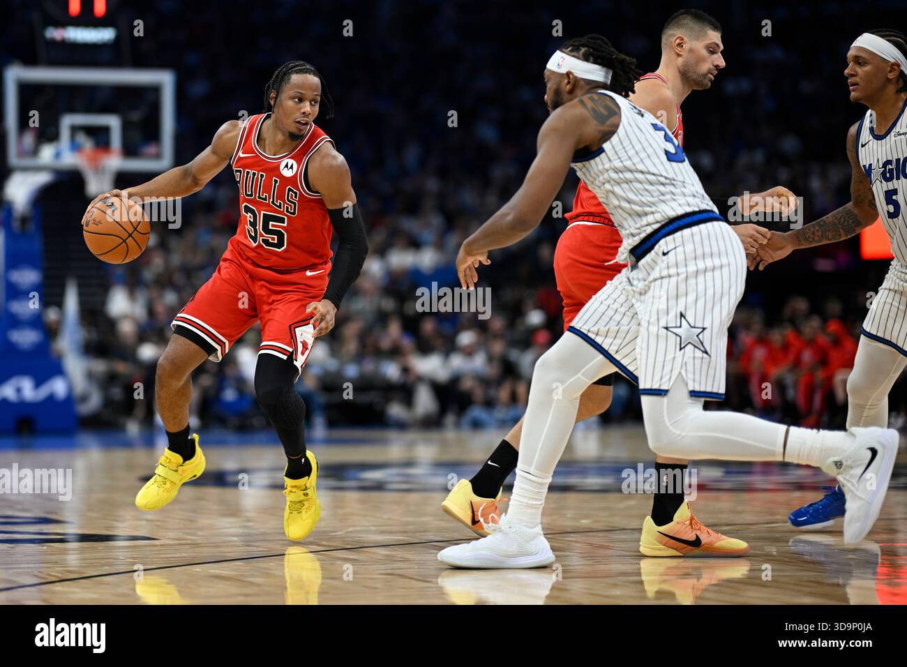 Chicago Bulls forward Isaac Okoro (35) is defended by Orlando Magic ...