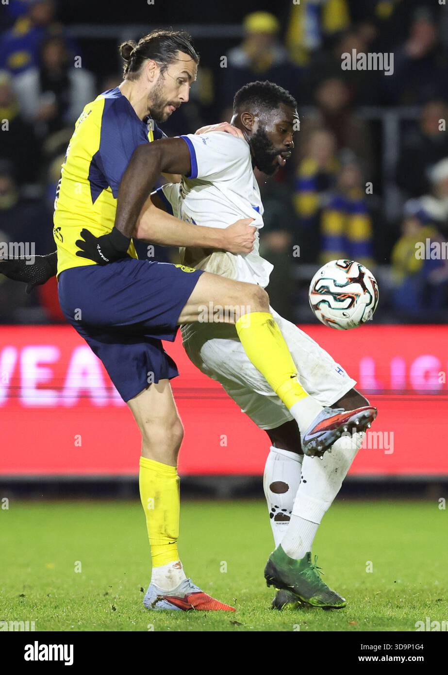 Union's Christian Burgess and Gent's Wilfried Kanga fight for the ball ...