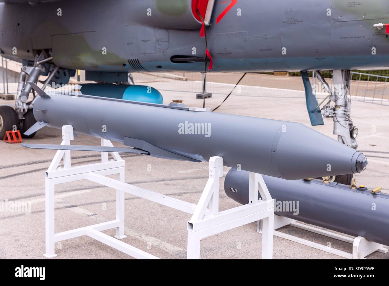 Military guided missile showcased on a support stand in front of a ...
