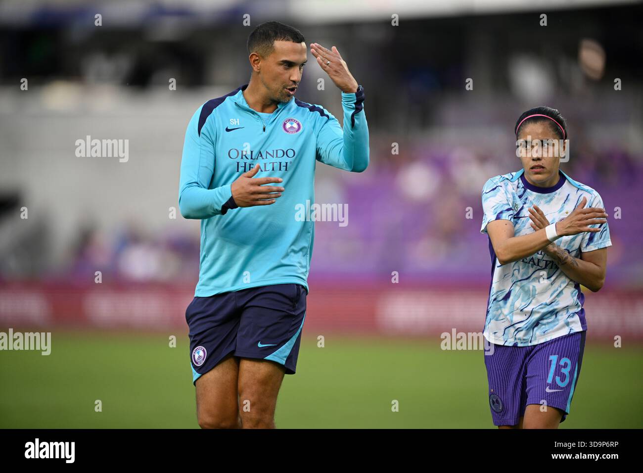 Orlando Pride head coach Seb Hines, left, talks with forward Jacquie ...