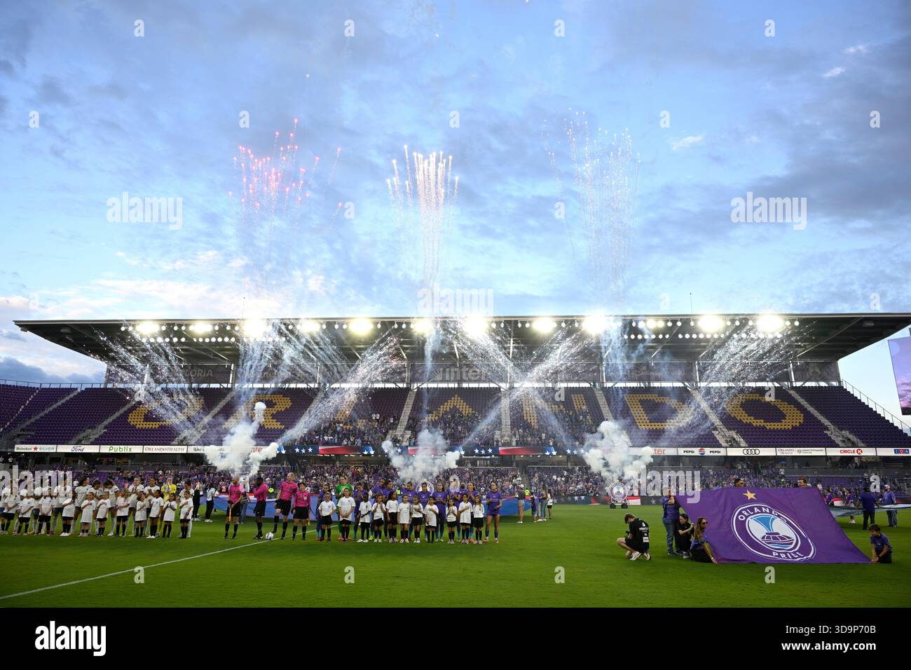 Seattle Reign FC players, left, and Orlando Pride players stand on the ...