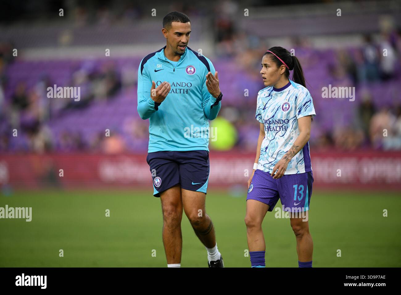 Orlando Pride head coach Seb Hines, left, talks with forward Jacquie ...