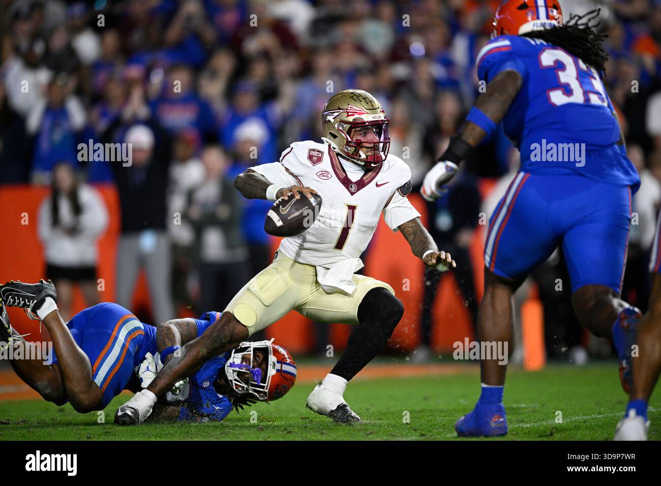 Florida State quarterback Tommy Castellanos (1) is pressured by Florida ...