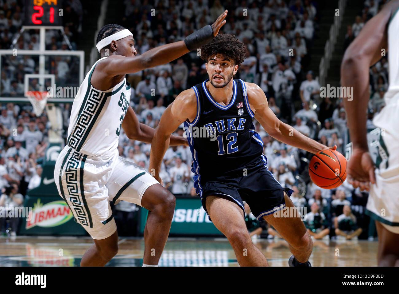 Duke forward Cameron Boozer (12), right, drives against Michigan State ...