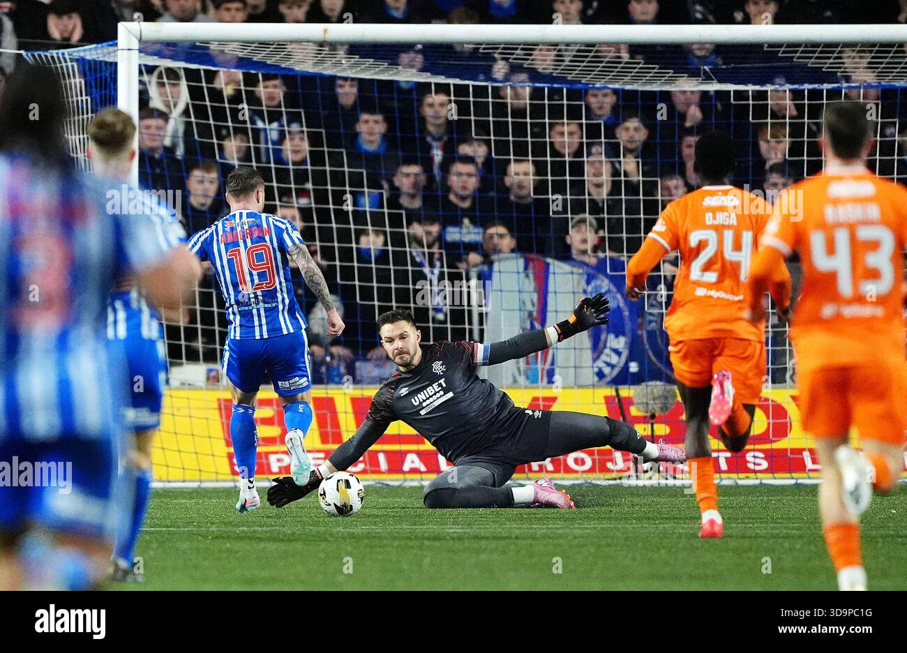 Rangers goalkeeper Jack Butland saves at the feet of Kilmarnock's Bruce ...