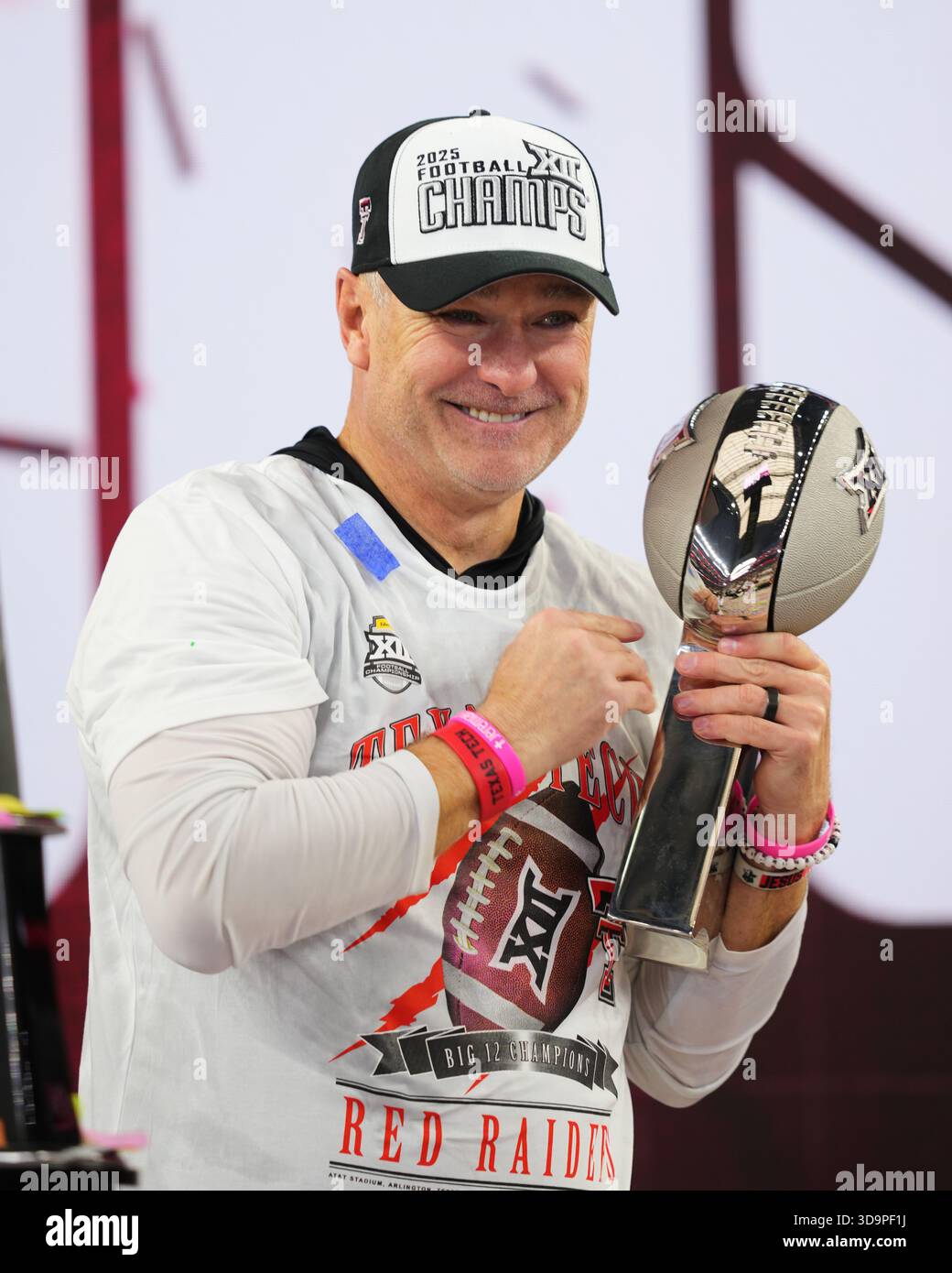 Texas Tech head coach Joey McGuire holds up the trophy after his team's ...