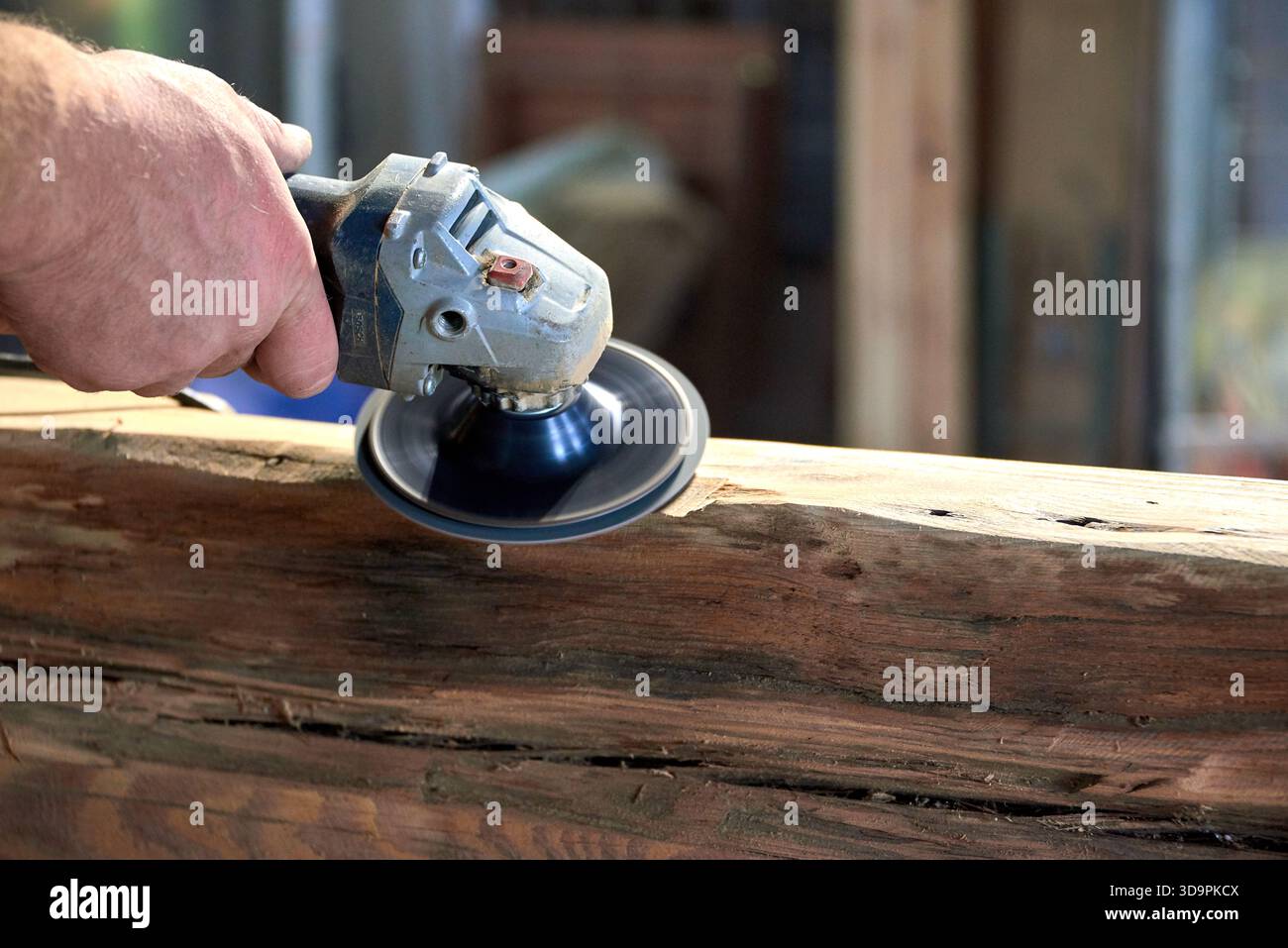 Carpenter uses handheld power sander hi-res stock photography and ...