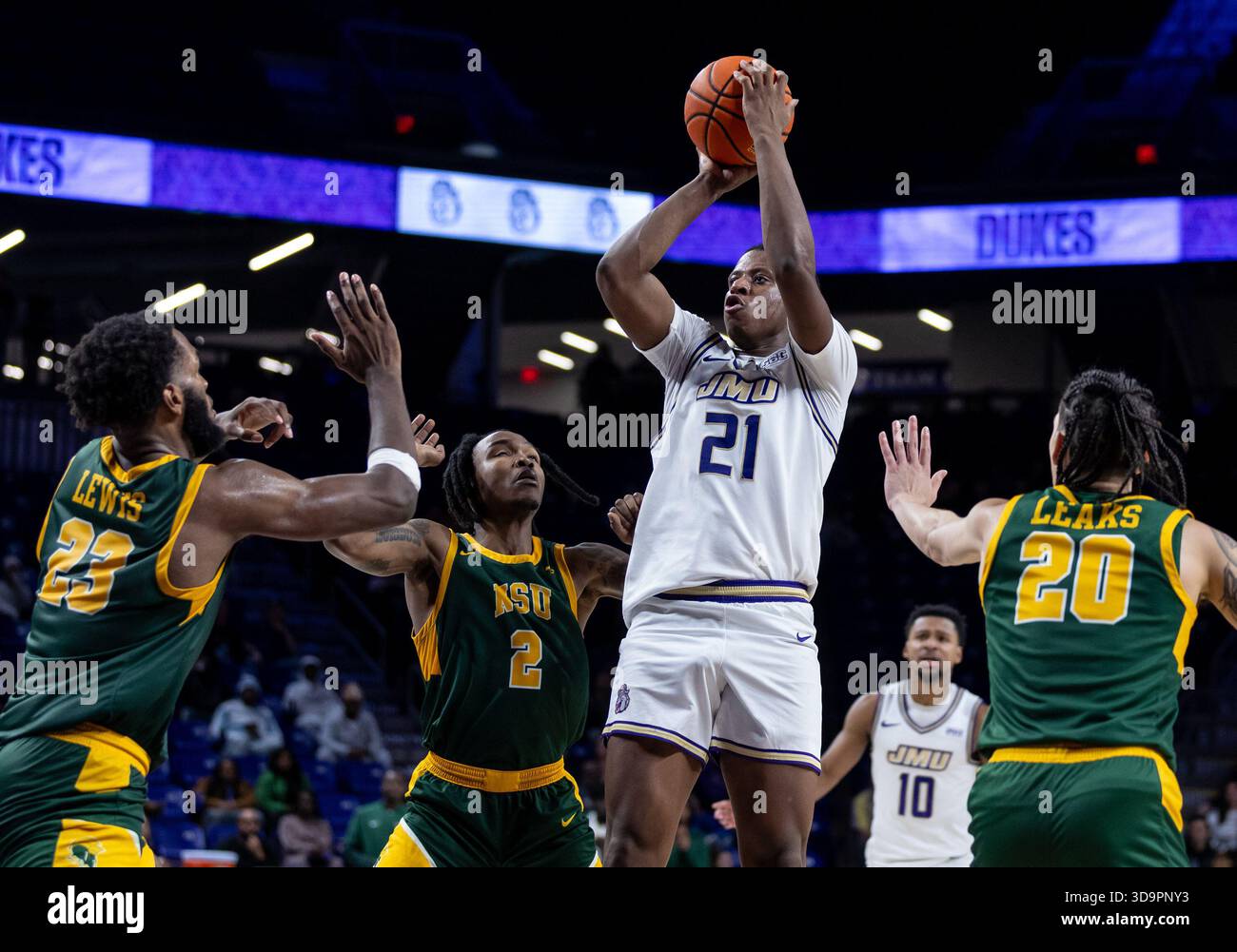 James Madison forward Justin McBride (21) goes up for a shot over ...