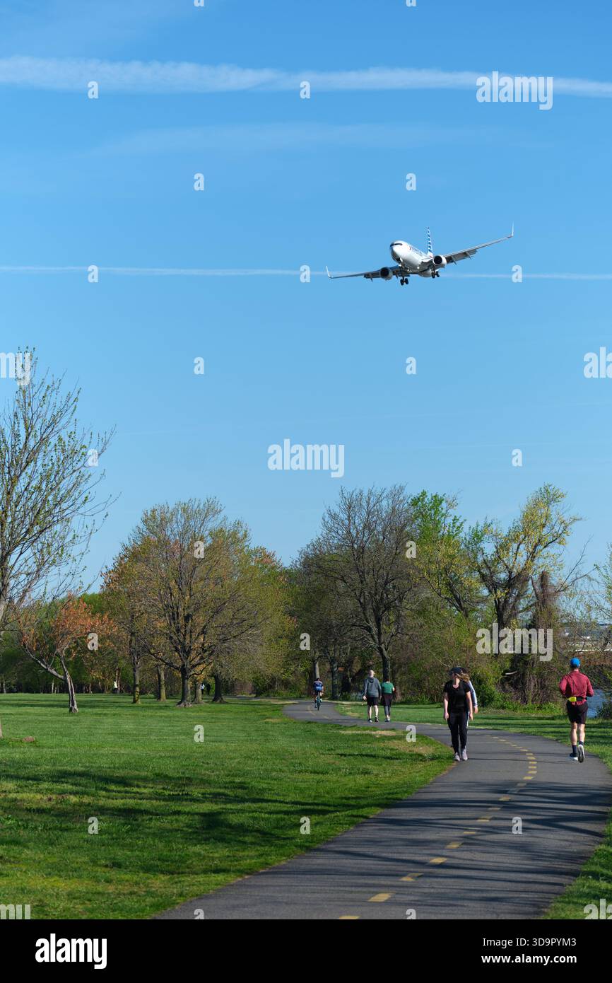 American Eagle airplane landing over bike track and Potomak river in ...