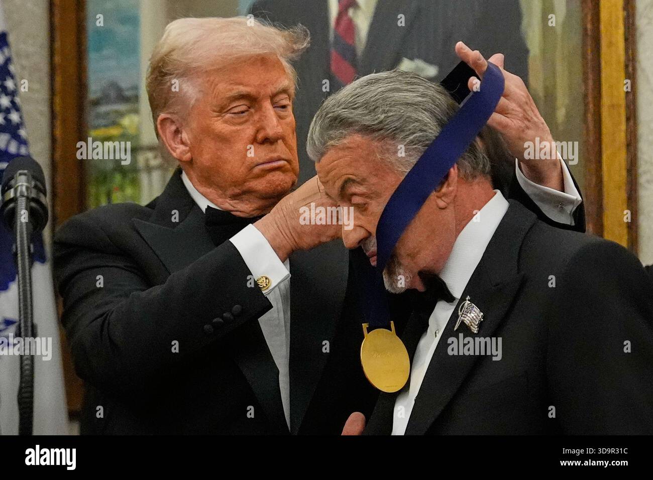 President Donald Trump, left, presents Sylvester Stallone with his ...