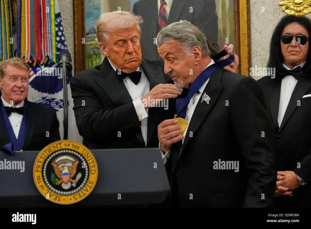 President Donald Trump, left, presents Sylvester Stallone with his ...