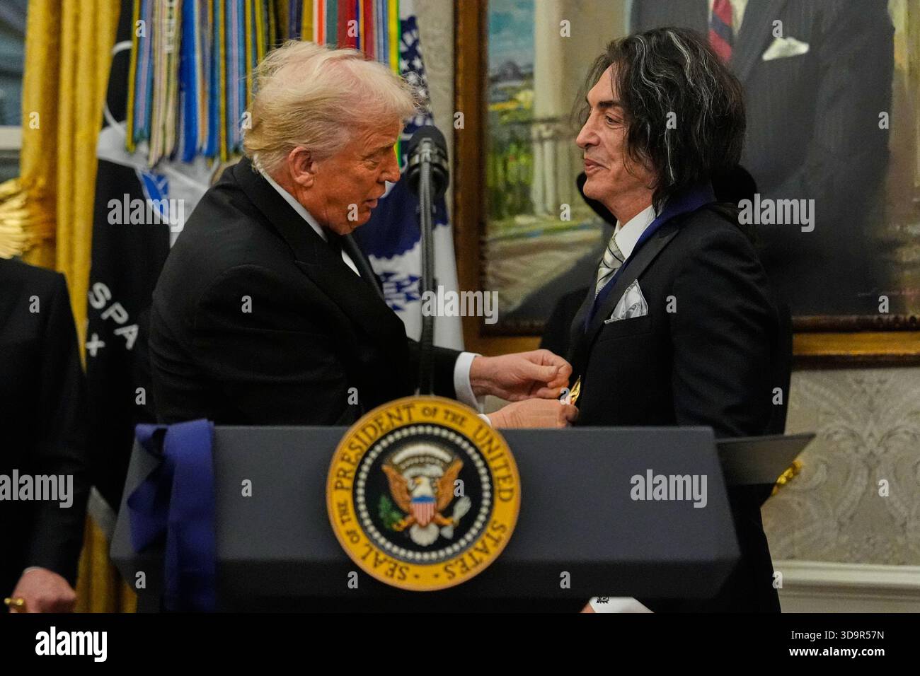 President Donald Trump, left, presents Paul Stanley, a member of the ...