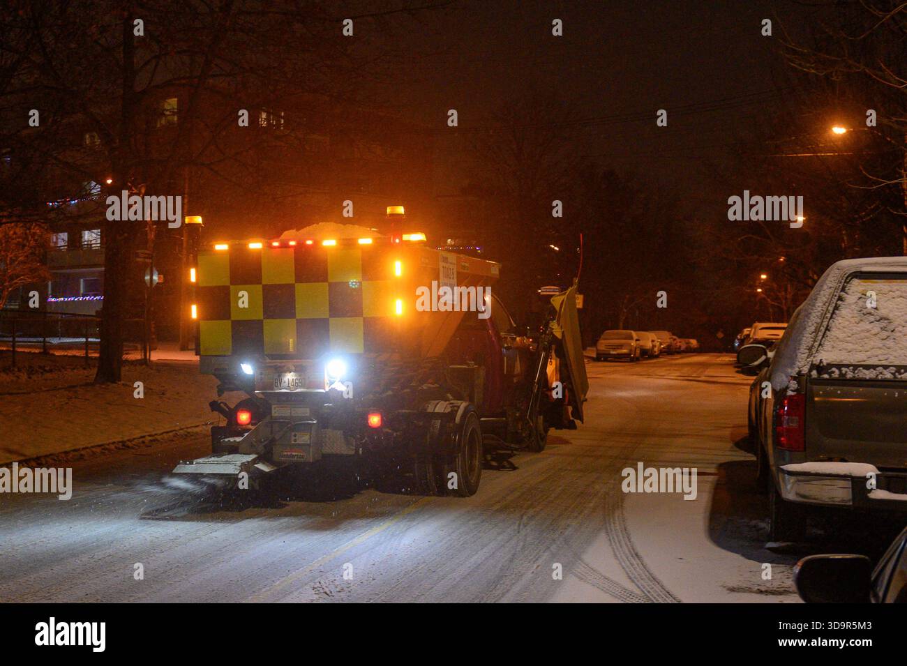 Toronto, ON, Canada - December 6, 2025: An orange salt spreader truck ...