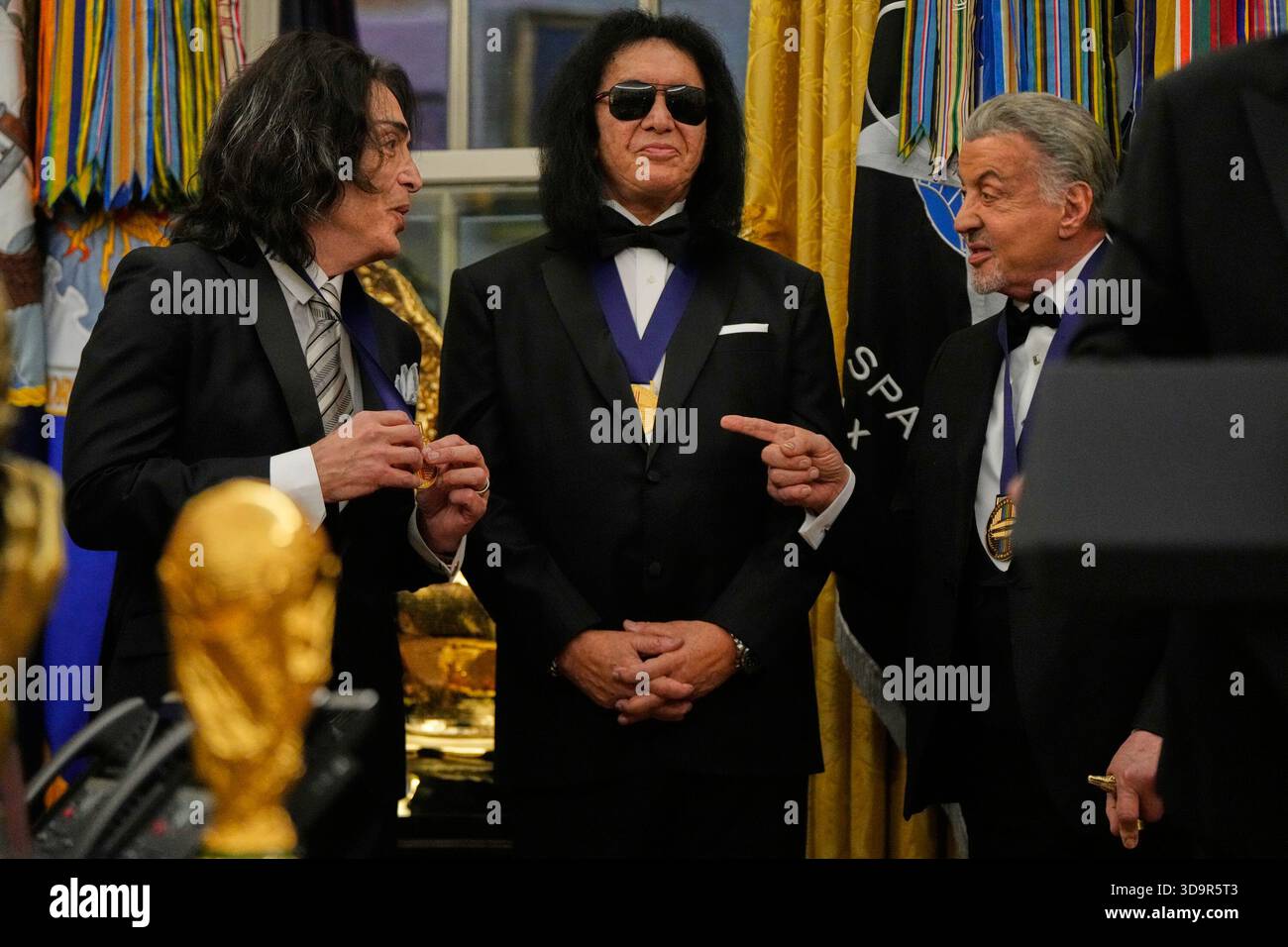 Sylvester Stallone, right, talks with Paul Stanley, left, and Gene ...