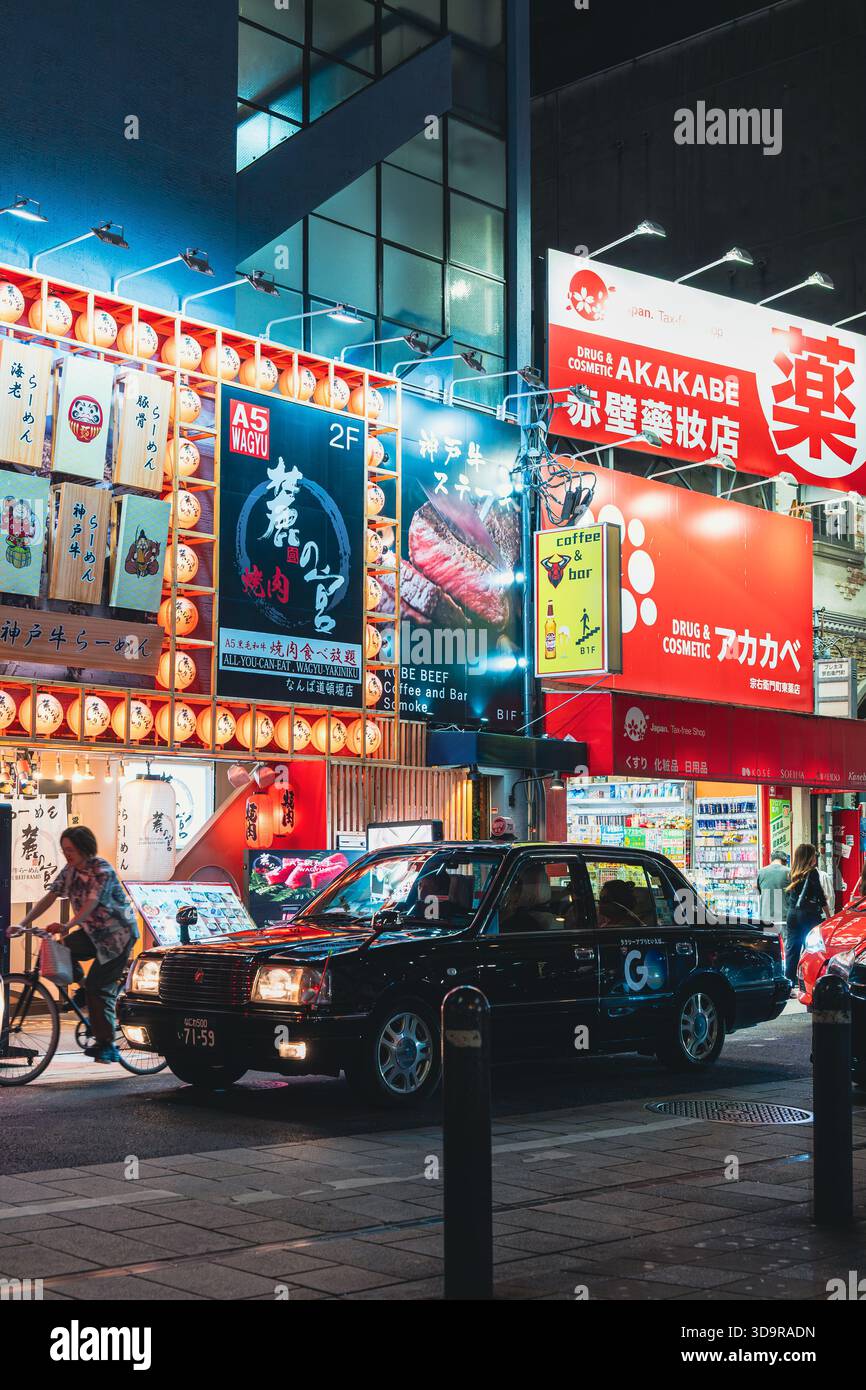 Osaka's lively Dotonbori street is illuminated by traditional lanterns ...