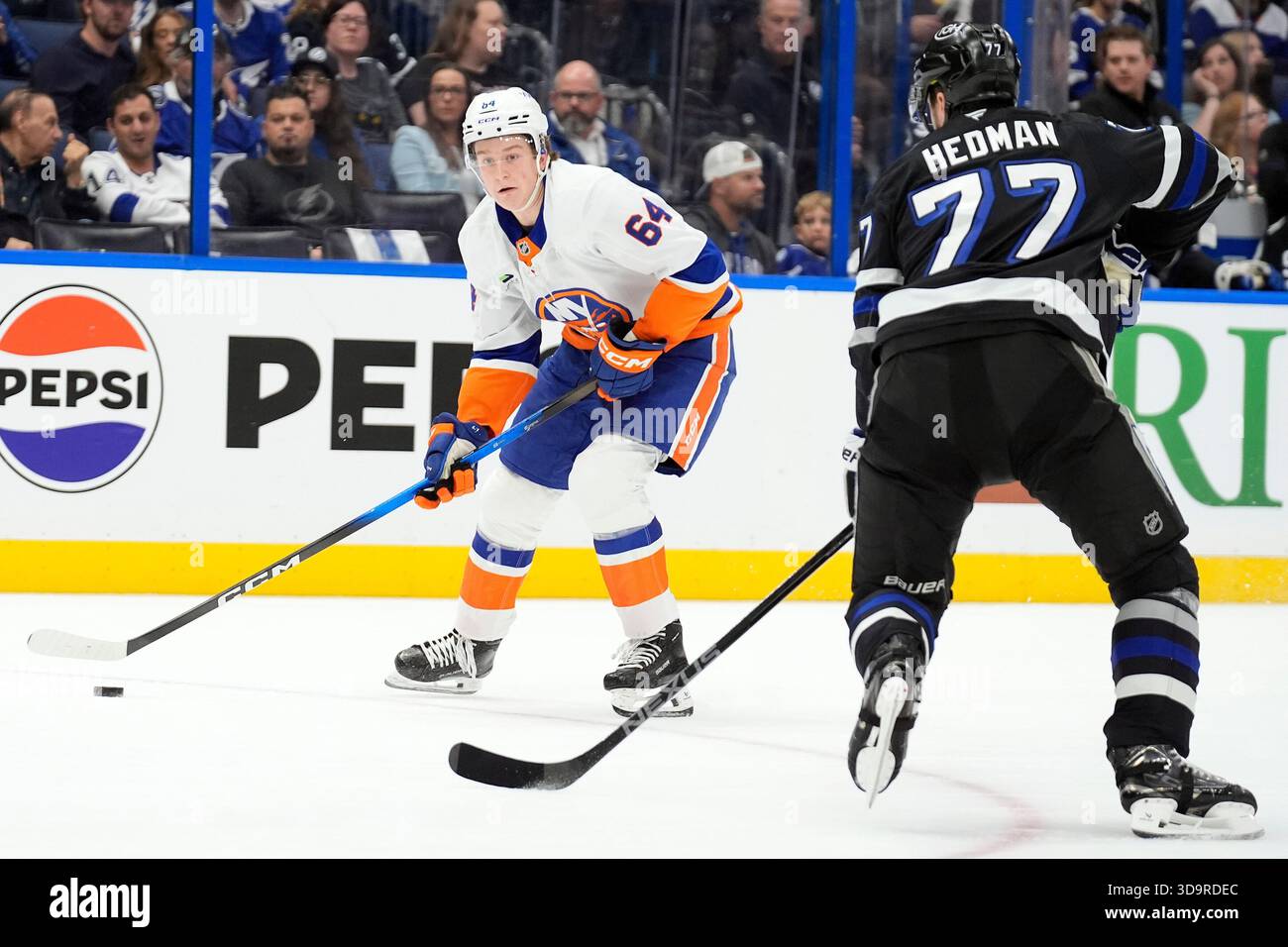 New York Islanders center Calum Ritchie (64) looks to pass around Tampa ...
