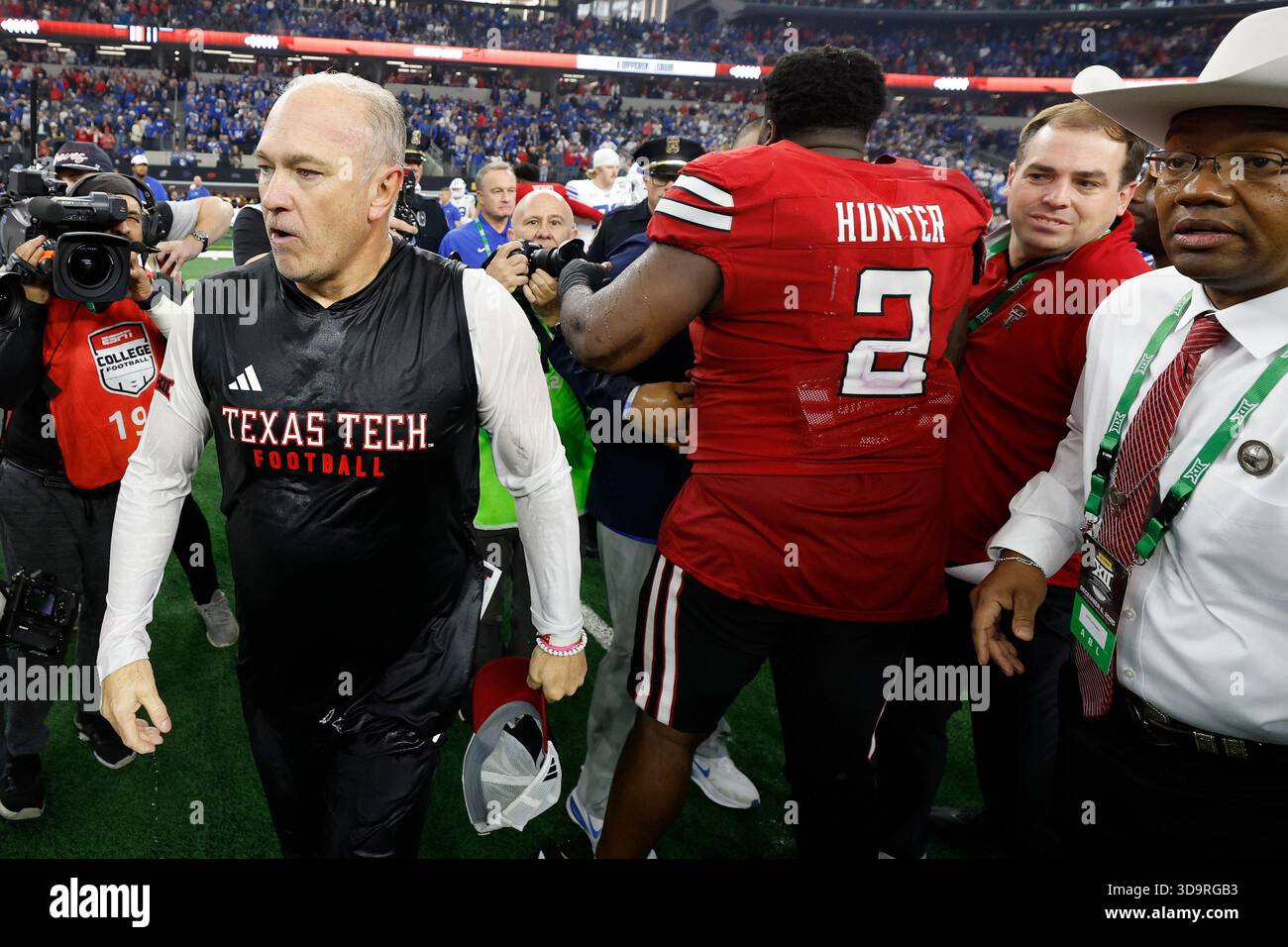 Texas Tech head coach Joey McGuire (left) walks on the field after a ...