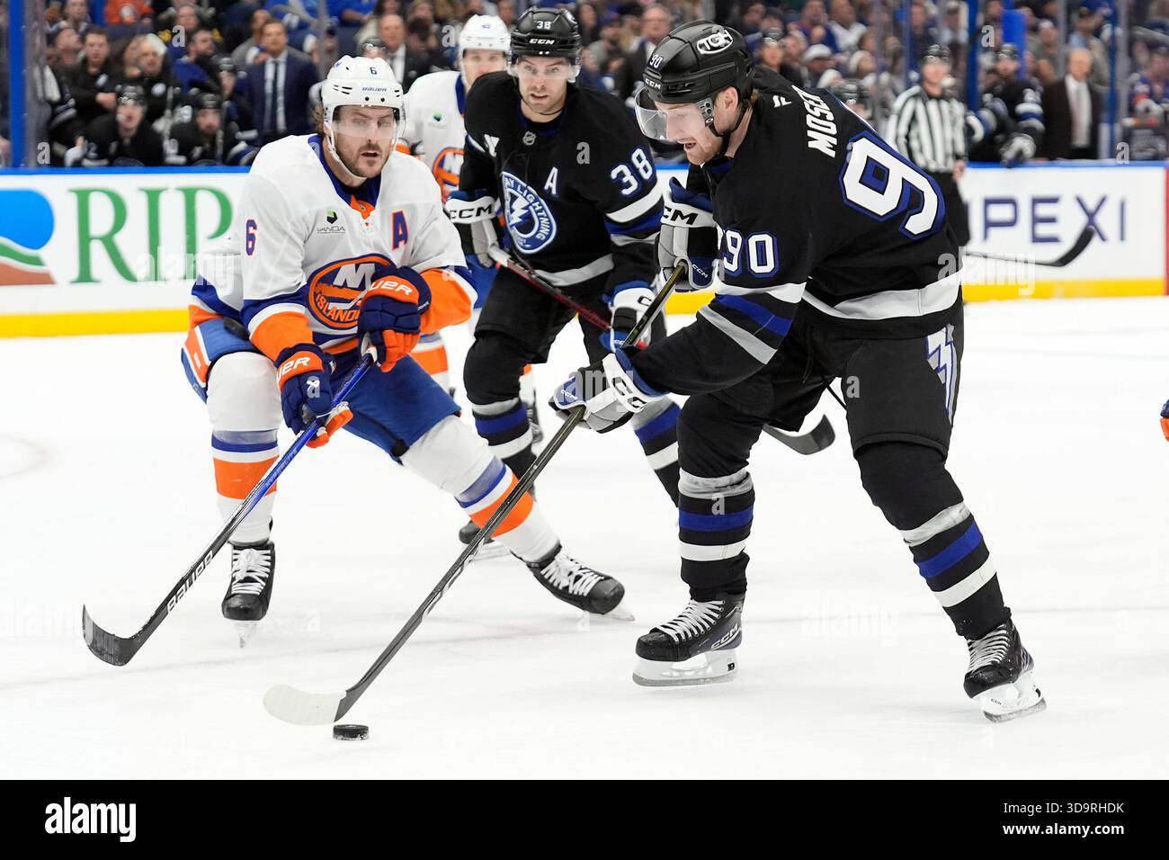 Tampa Bay Lightning defenseman J.J. Moser (90) shoots in front of New York Islanders defenseman ...