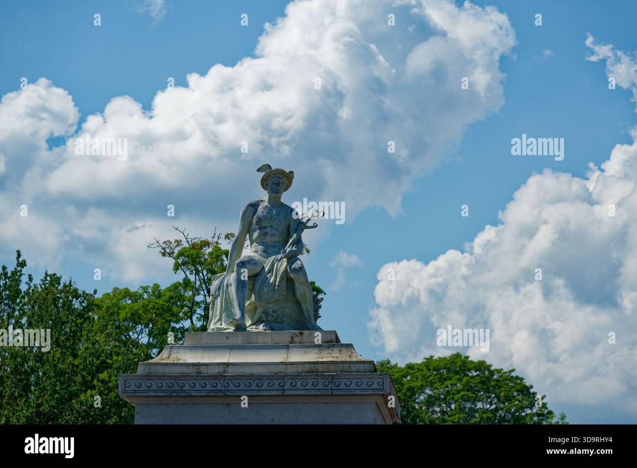 A majestic statue of a seated figure, possibly a goddess, atop a stone ...