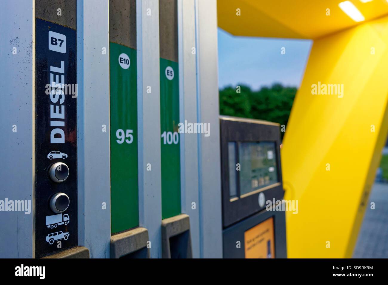 A fuel station shows pumps labeled diesel 95 and 100 petrol, with clear ...