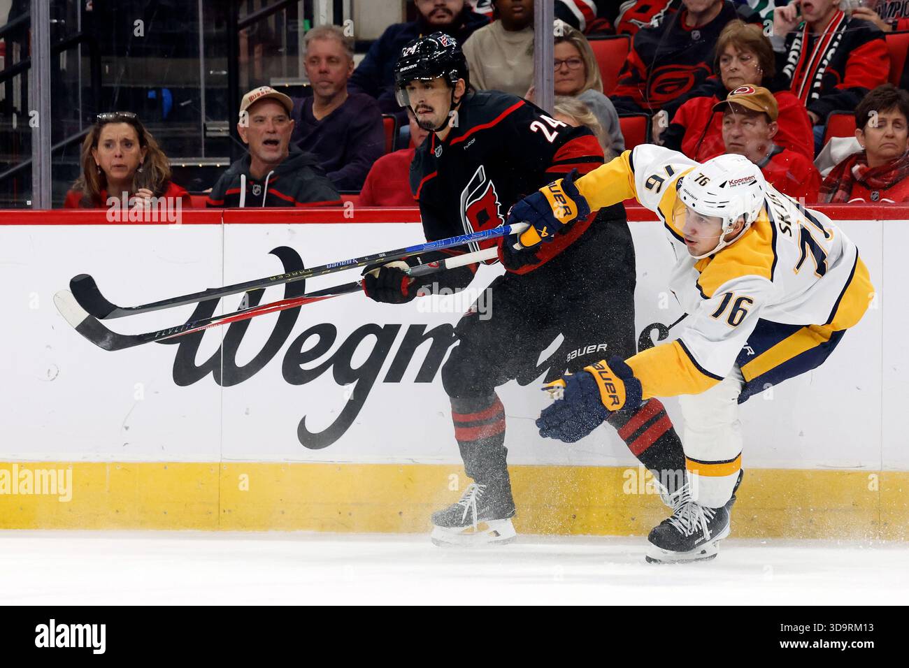 Carolina Hurricanes' Seth Jarvis (24) battles with Nashville Predators' Brady Skjei (76) during ...