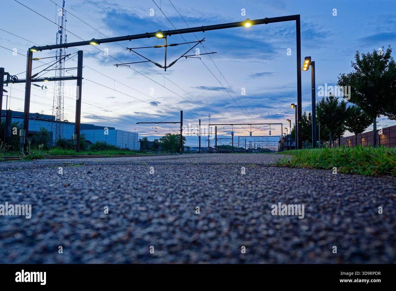 Two tall poles support a crossbeam that carries lamps and the overhead ...