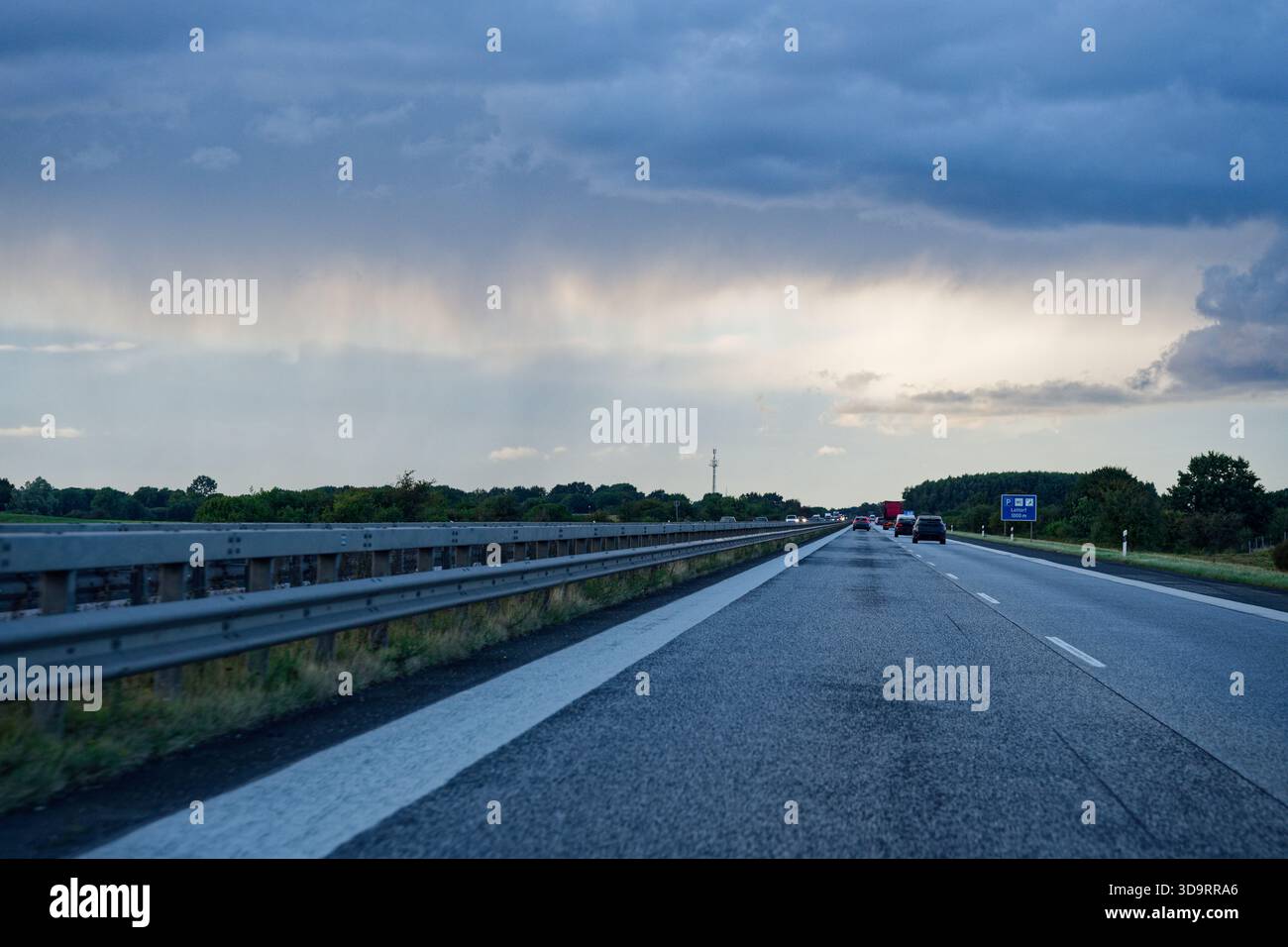 A7 highway runs beneath a dramatic sky, layered clouds piling high ...