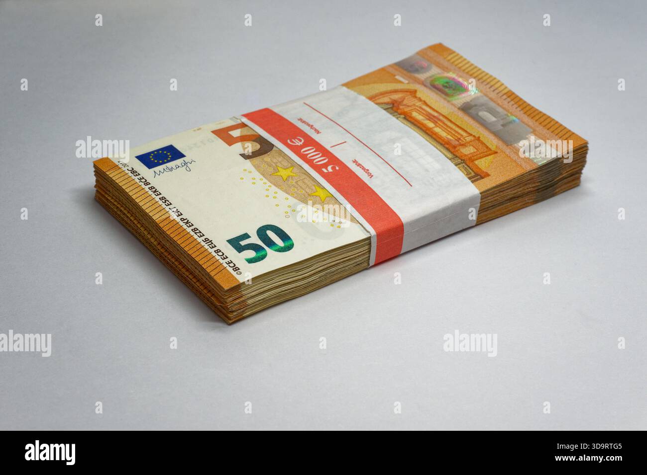 Bundle of 50 euro notes with paper band labeled 5000€. Concept photo ...