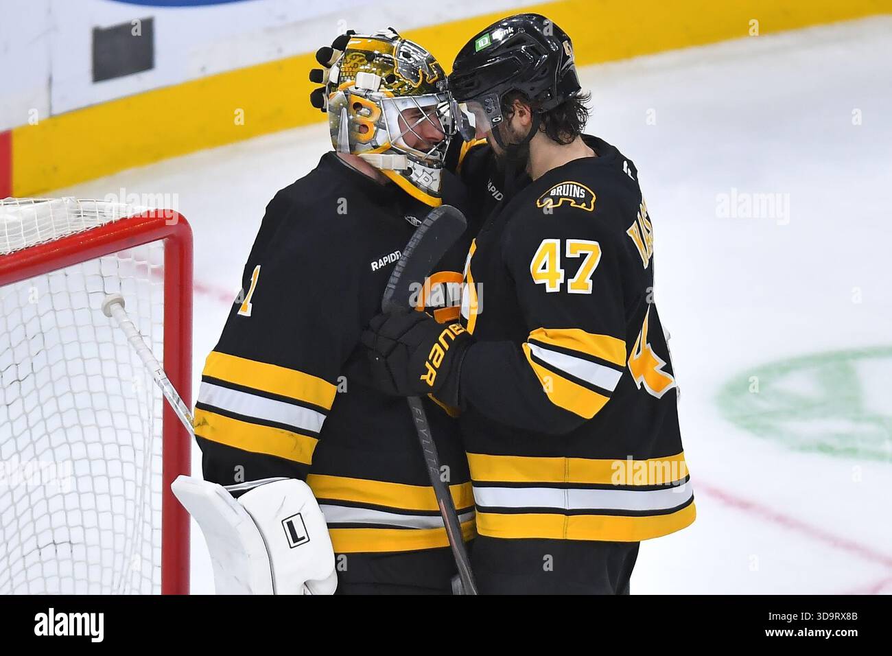 Boston Bruins goaltender Jeremy Swayman (1) celebrates with center Mark ...