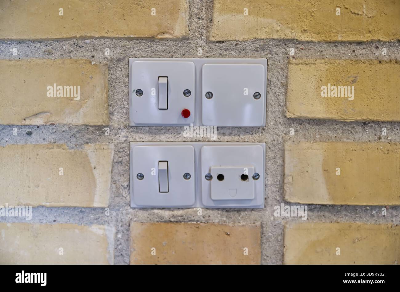 A close-up view of electrical switches and a socket mounted on a ...