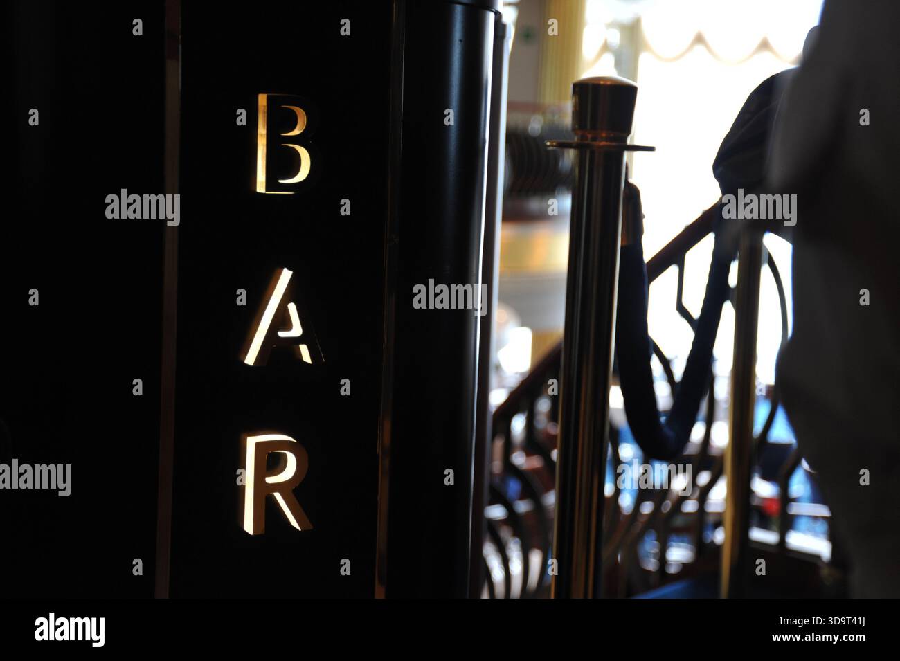 A close-up of a bar sign with illuminated letters spelling BAR. The ...