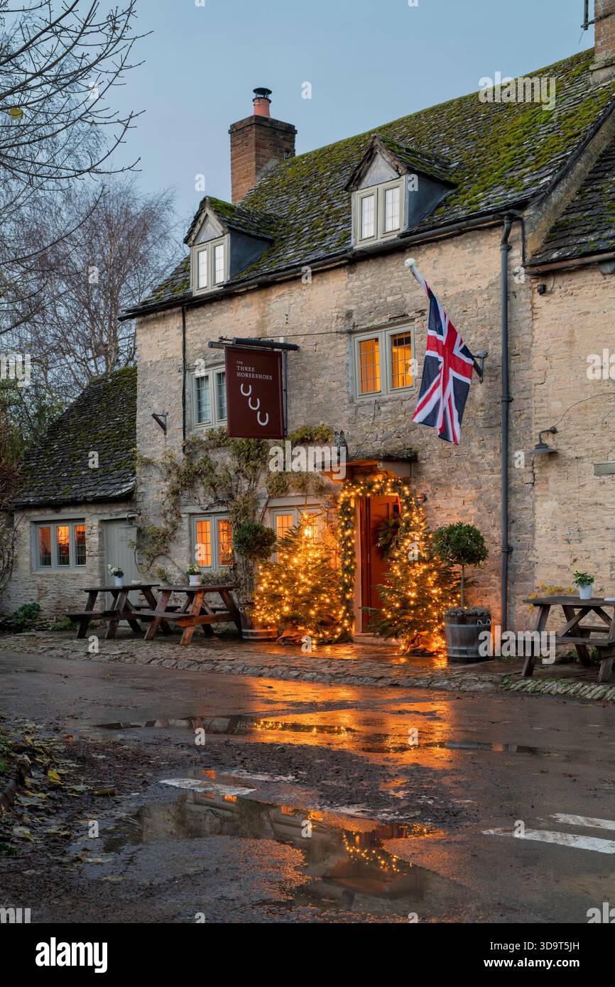 Christmas trees and lights outside The Three Horseshoes pub in December ...